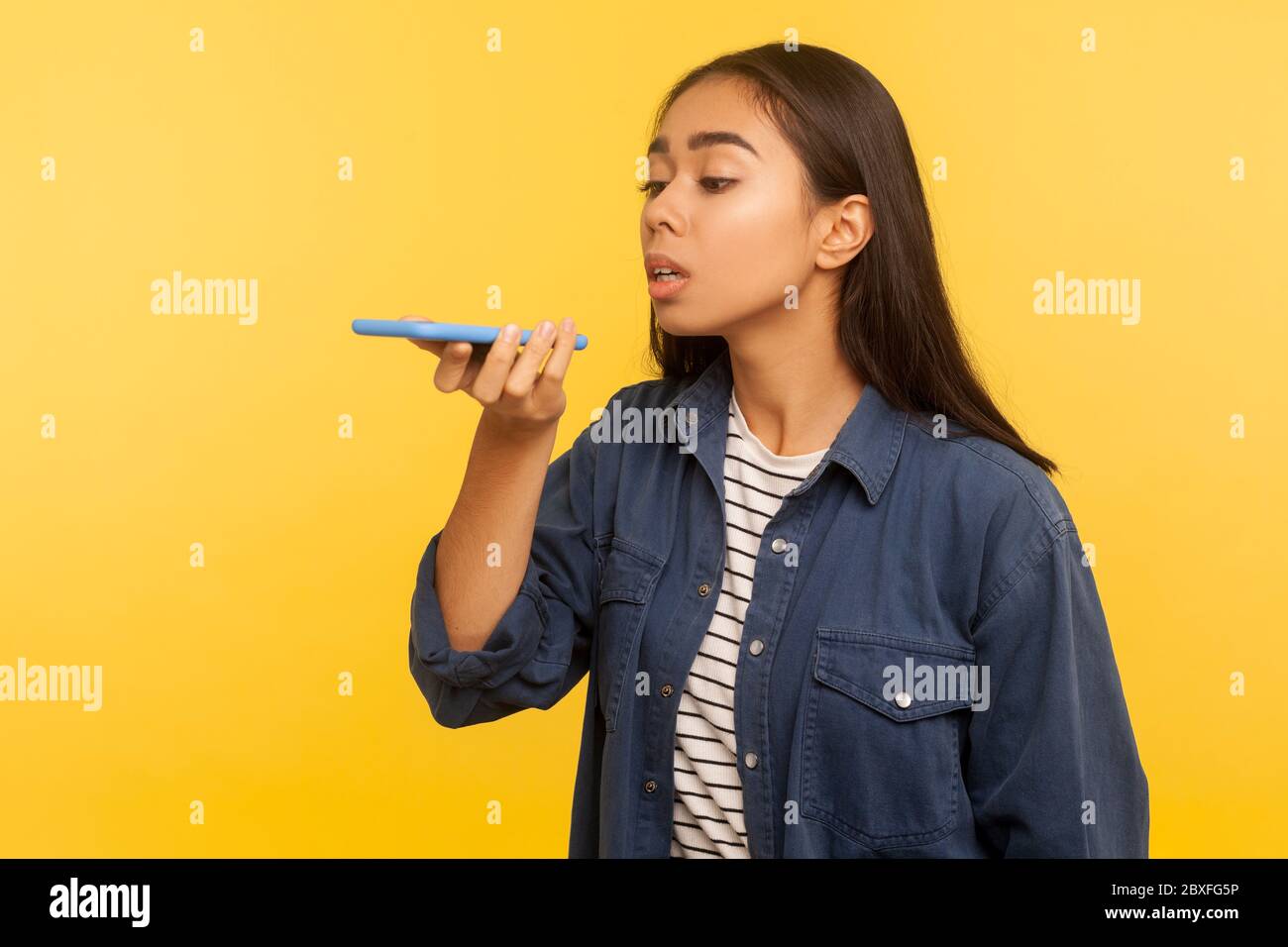 Digital assistant application. Portrait of girl in denim shirt talking ...