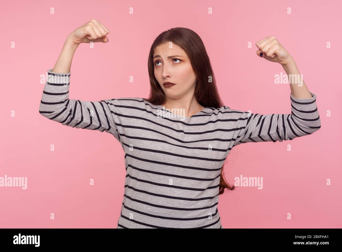 I am strong! Portrait of confident independent woman in striped ...