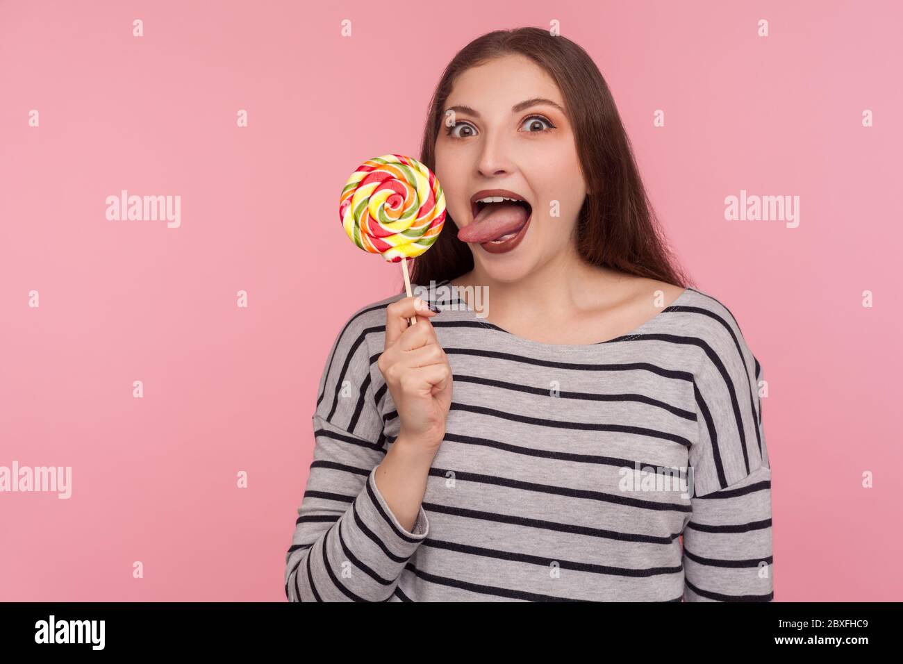 Portrait Of Funny Woman Sticking Out Tongue Licking Lollipop Tasting