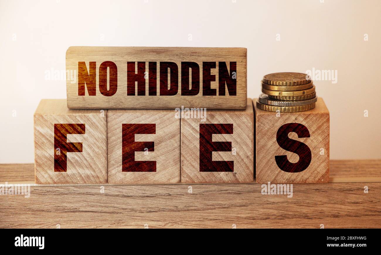 No hidden fees word written on wood blocks and pill of coins. Business ...