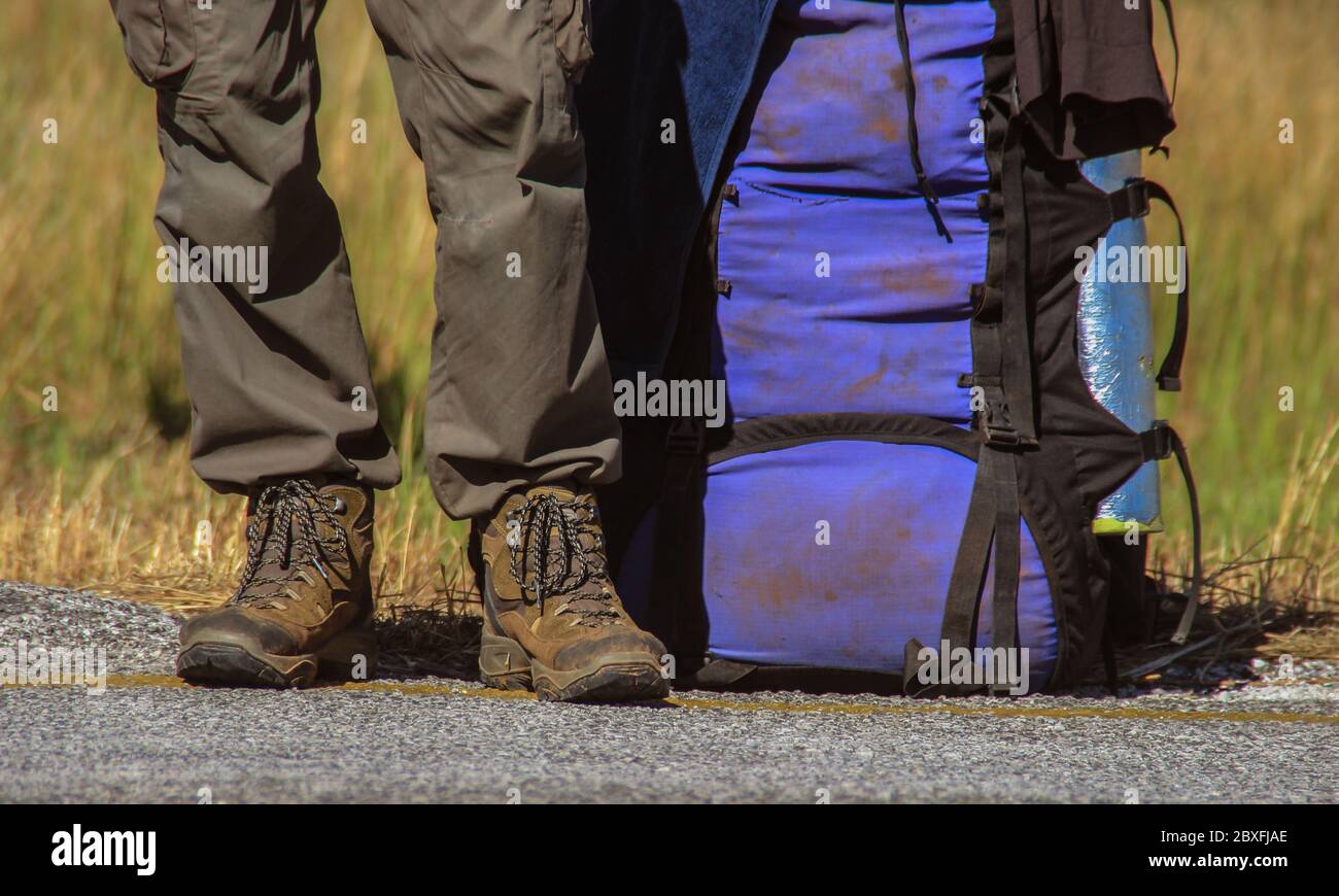Men's legs in trekking boots and shorts and a backpack Stock Photo - Alamy
