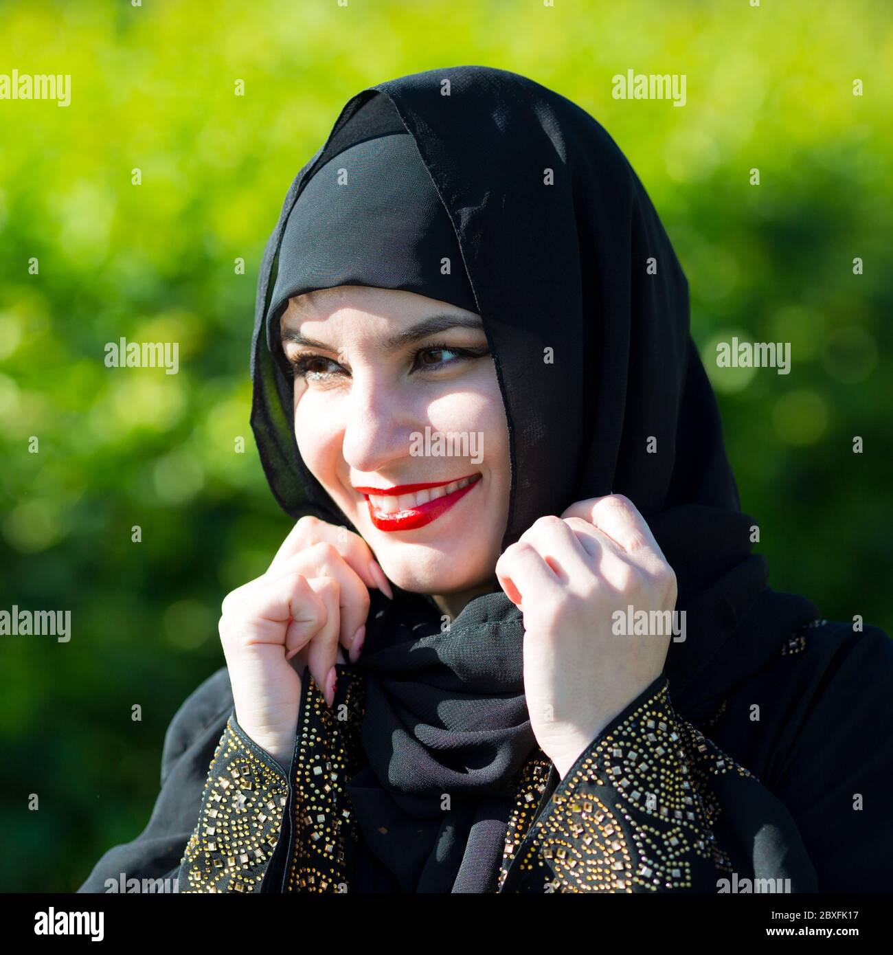 Beautiful young muslim woman smiles broadly Stock Photo - Alamy