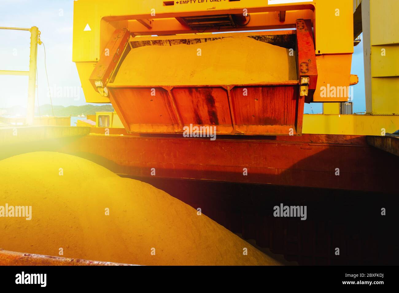 Raw sugar bulk loaded into large vessel hole by rotainer for export ...