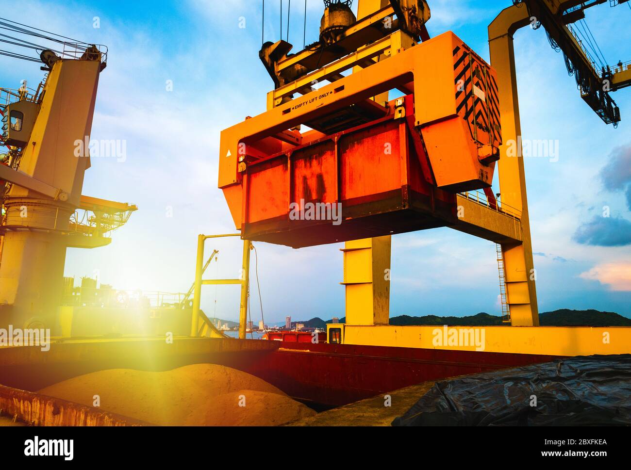 Raw sugar bulk loaded into large vessel hole by rotainer for export ...