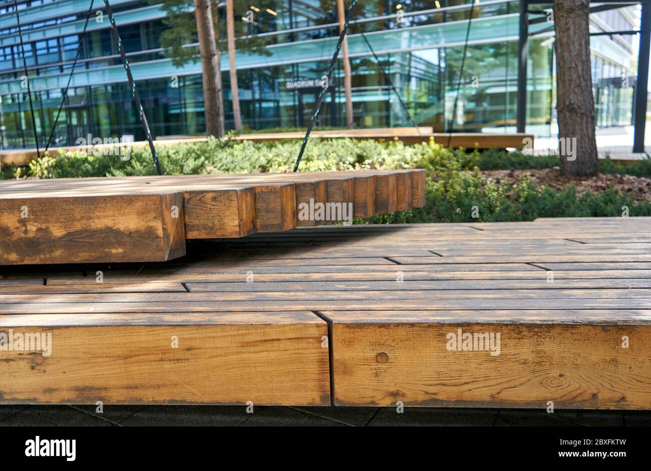 Nice bench in the square near the office building Stock Photo - Alamy