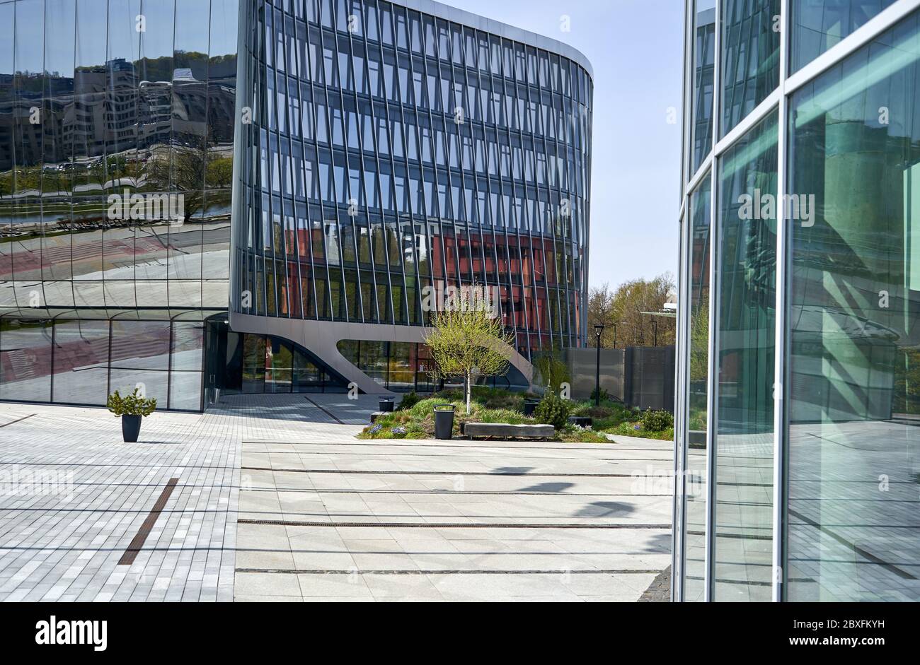 Modern office building and small garden near by Stock Photo - Alamy