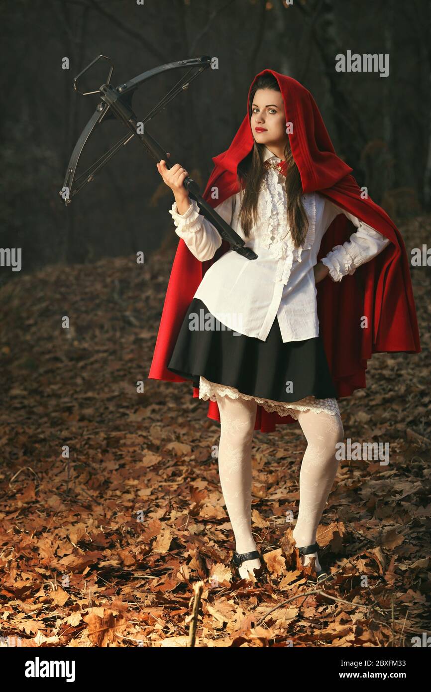 Little red riding hood proudly posing with her crossbow . Fashion wolf ...