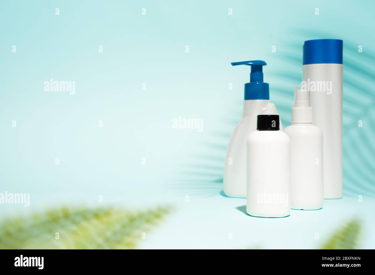White containers without labels for spray, liquid soap on clean blue ...