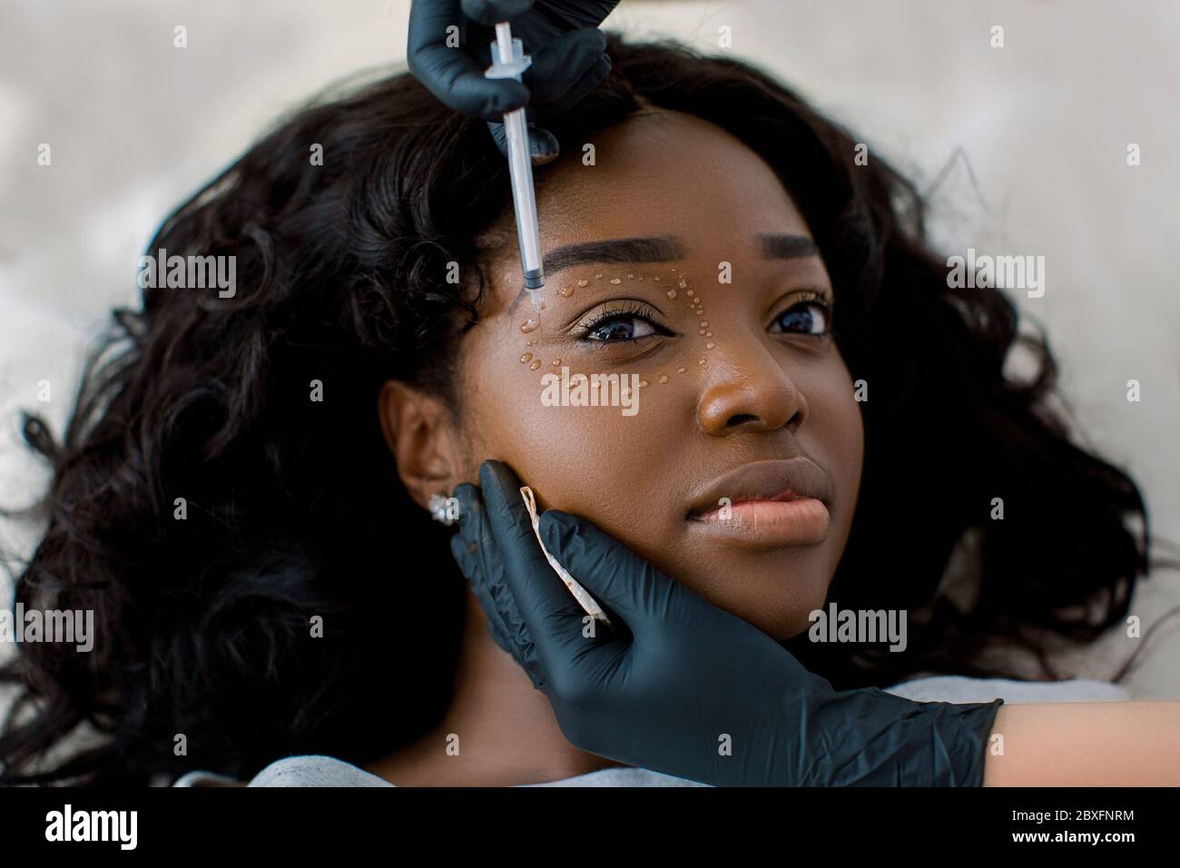 Close up of female cosmetologist doctor hands in black gloves making ...