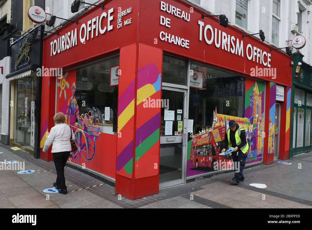 Putting down queue stickers on henry street hi-res stock photography ...