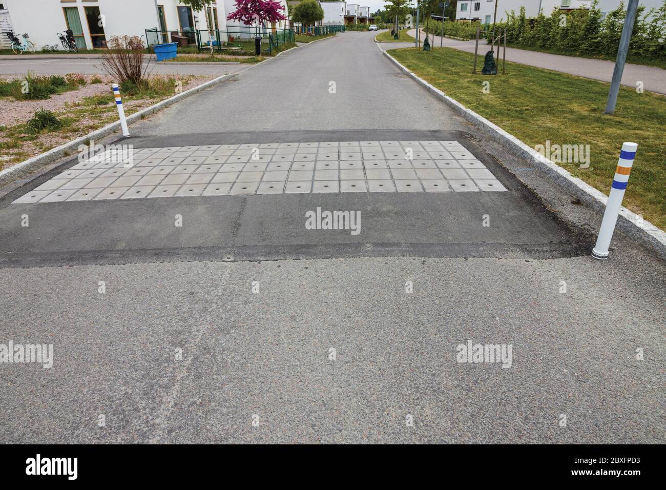 Close up view of speed bump on village street road. Landscape view ...