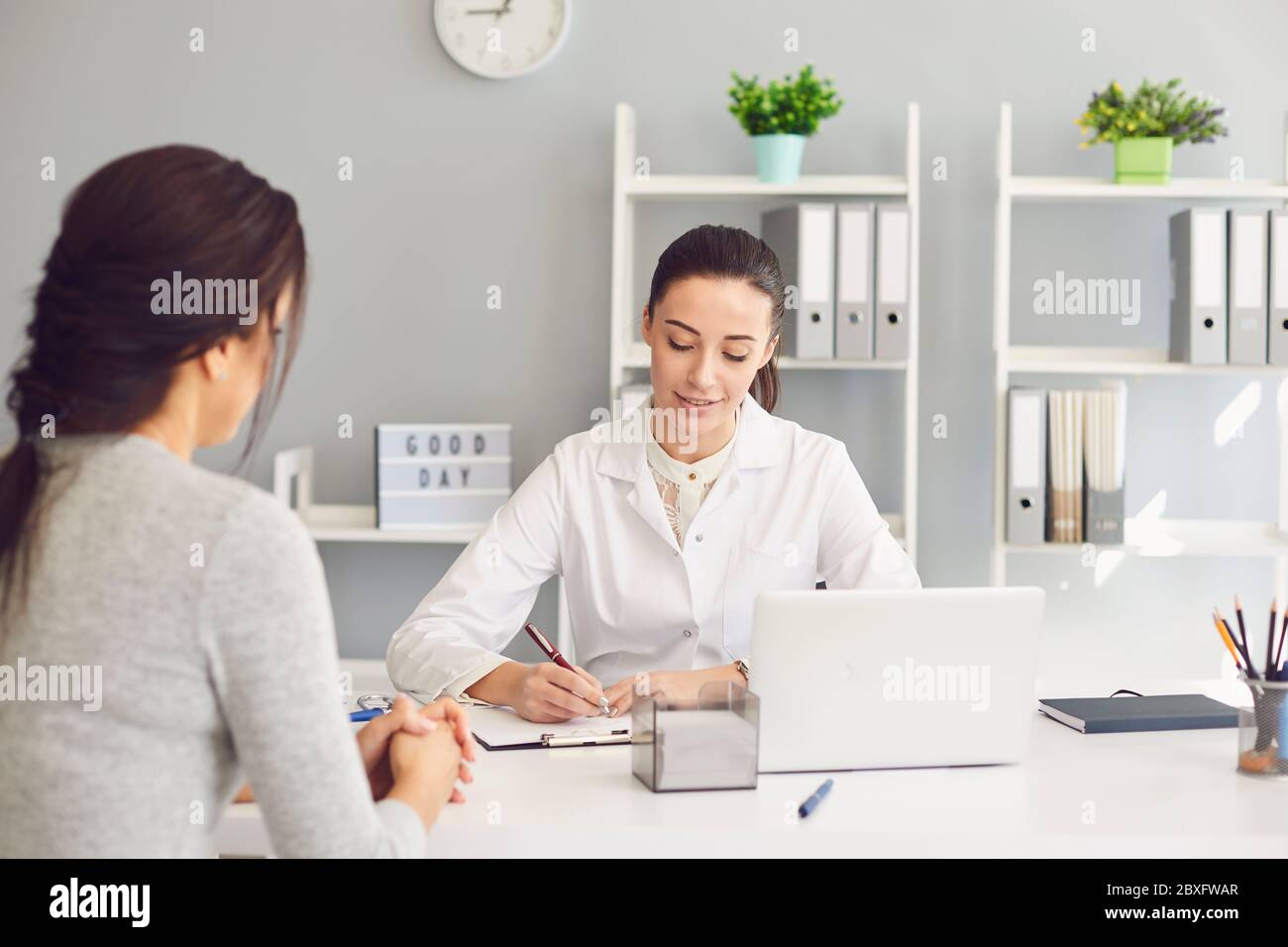 Woman patient visiting female doctor at clinic office. Medical work ...