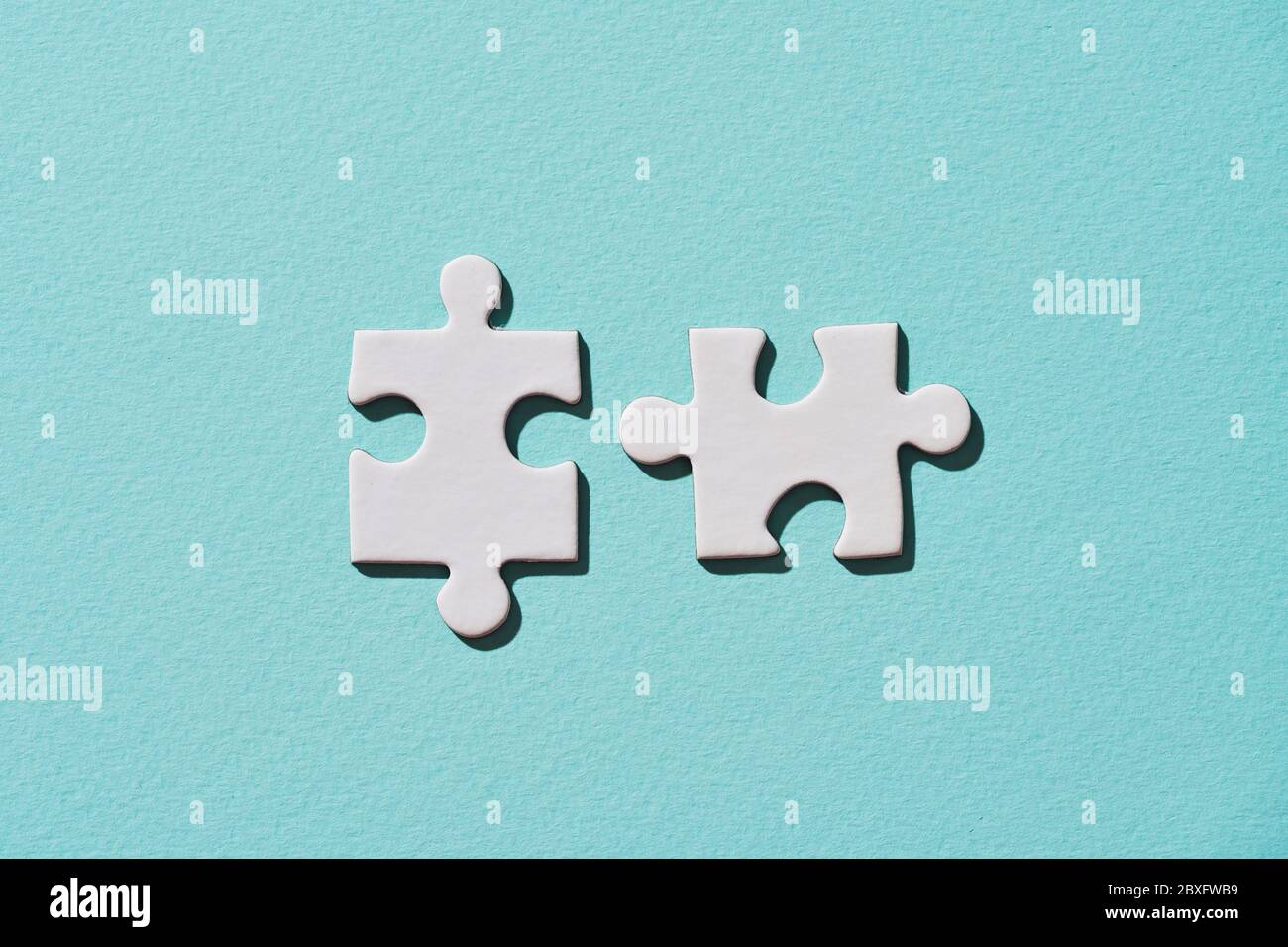 Two connecting puzzle piece. Concept of connection Stock Photo - Alamy