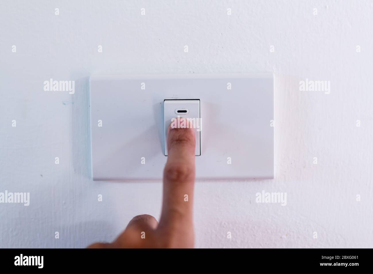 Close up of finger is turning on or off on light switch Stock Photo - Alamy
