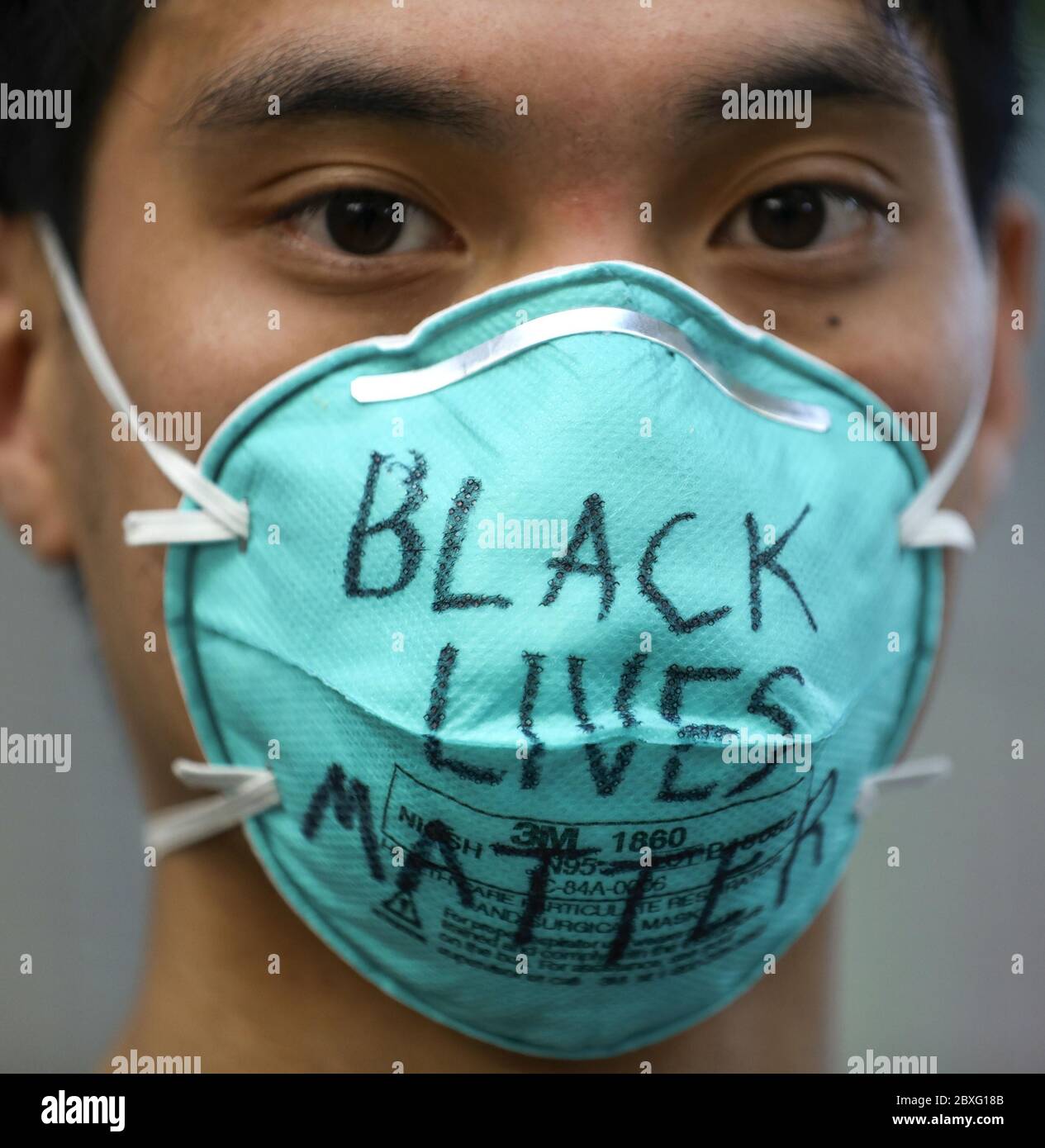 A man wears a face mask with a message during a protest in Osaka on ...