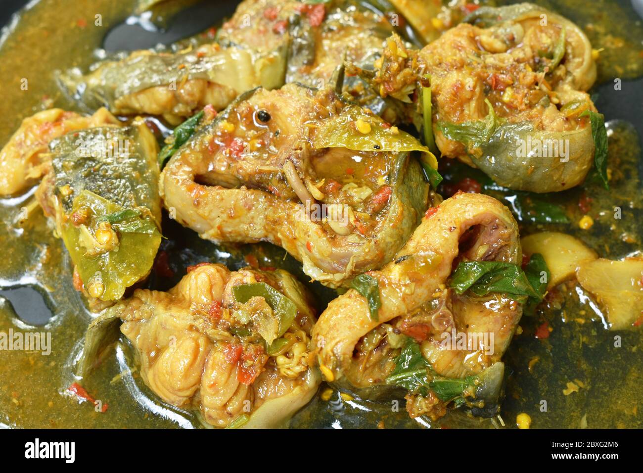 spicy stir fried catfish curry with herb on plate Stock Photo - Alamy