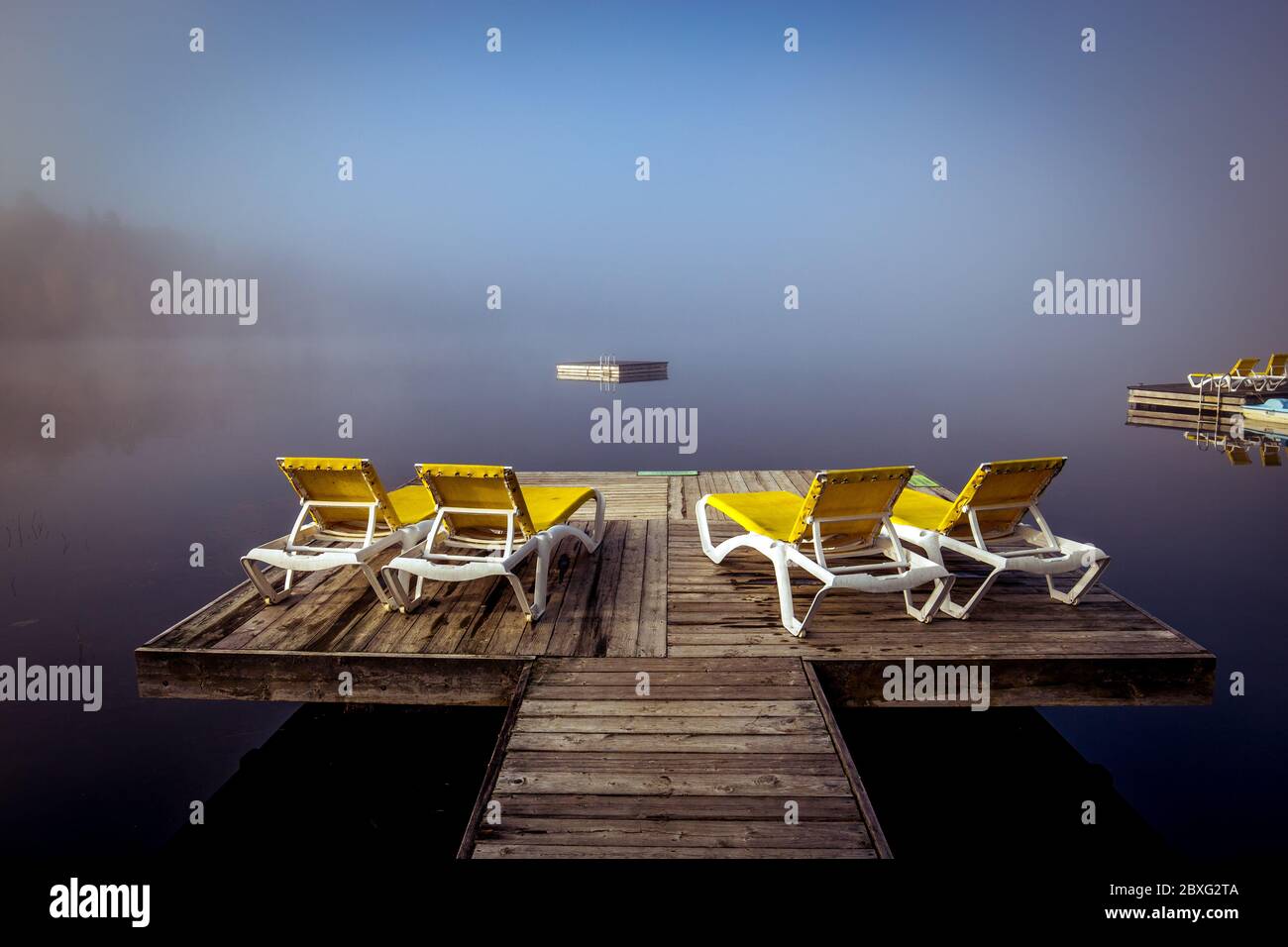 view of a boat dock the Lac-Superieur, misty morning with fog, in ...