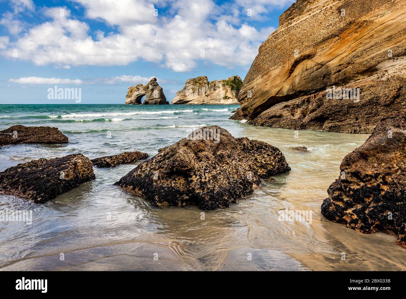 Famous rock formations on the Wharariki beach in National Park. Nelson ...