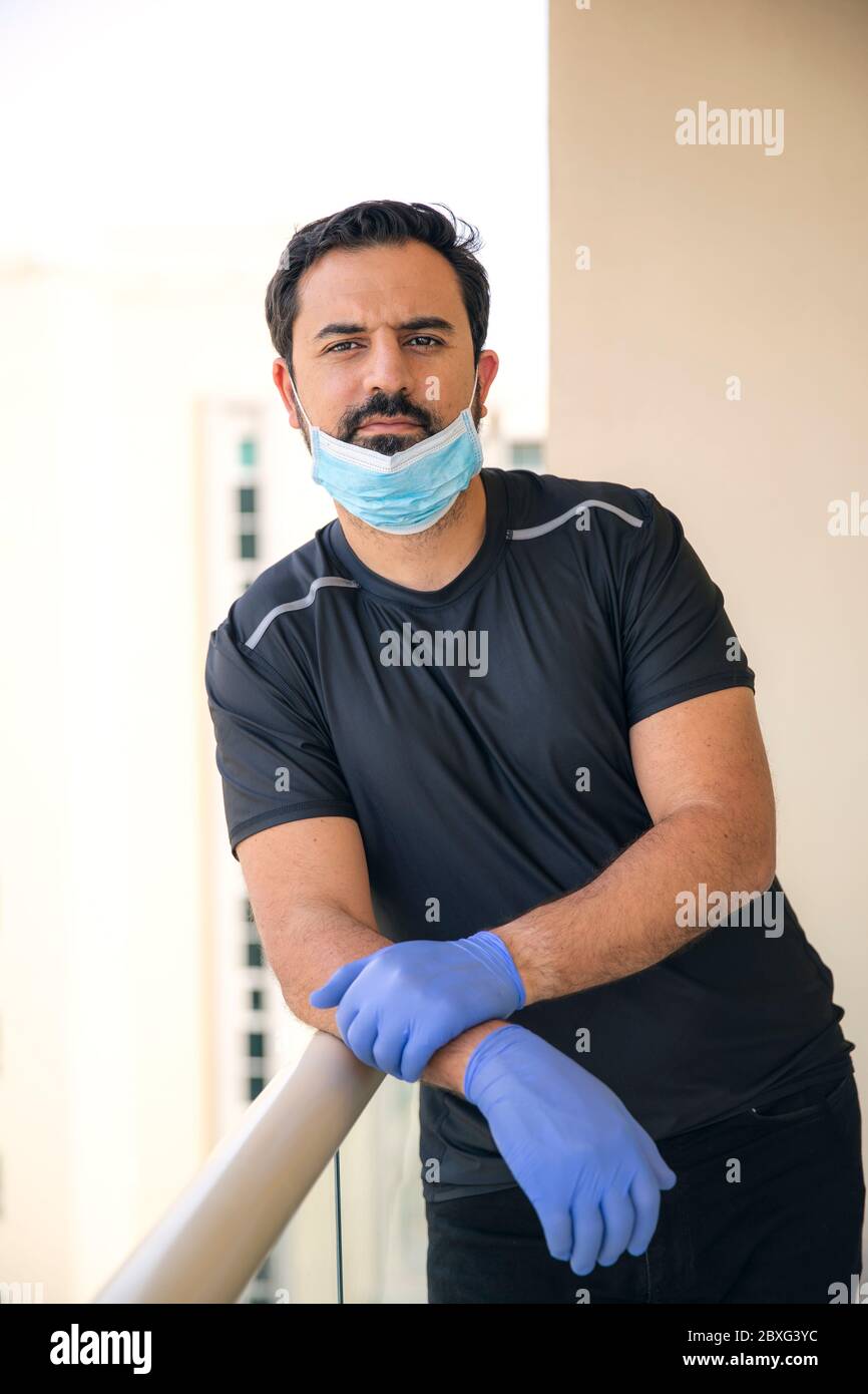 arab man wearing a mask and gloves to protect himself from a virus when ...