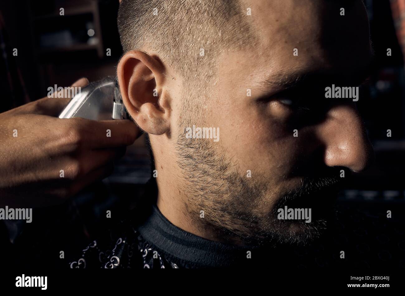 Barber cuts a guy at the hairdresser. Short haircut and alignment of ...