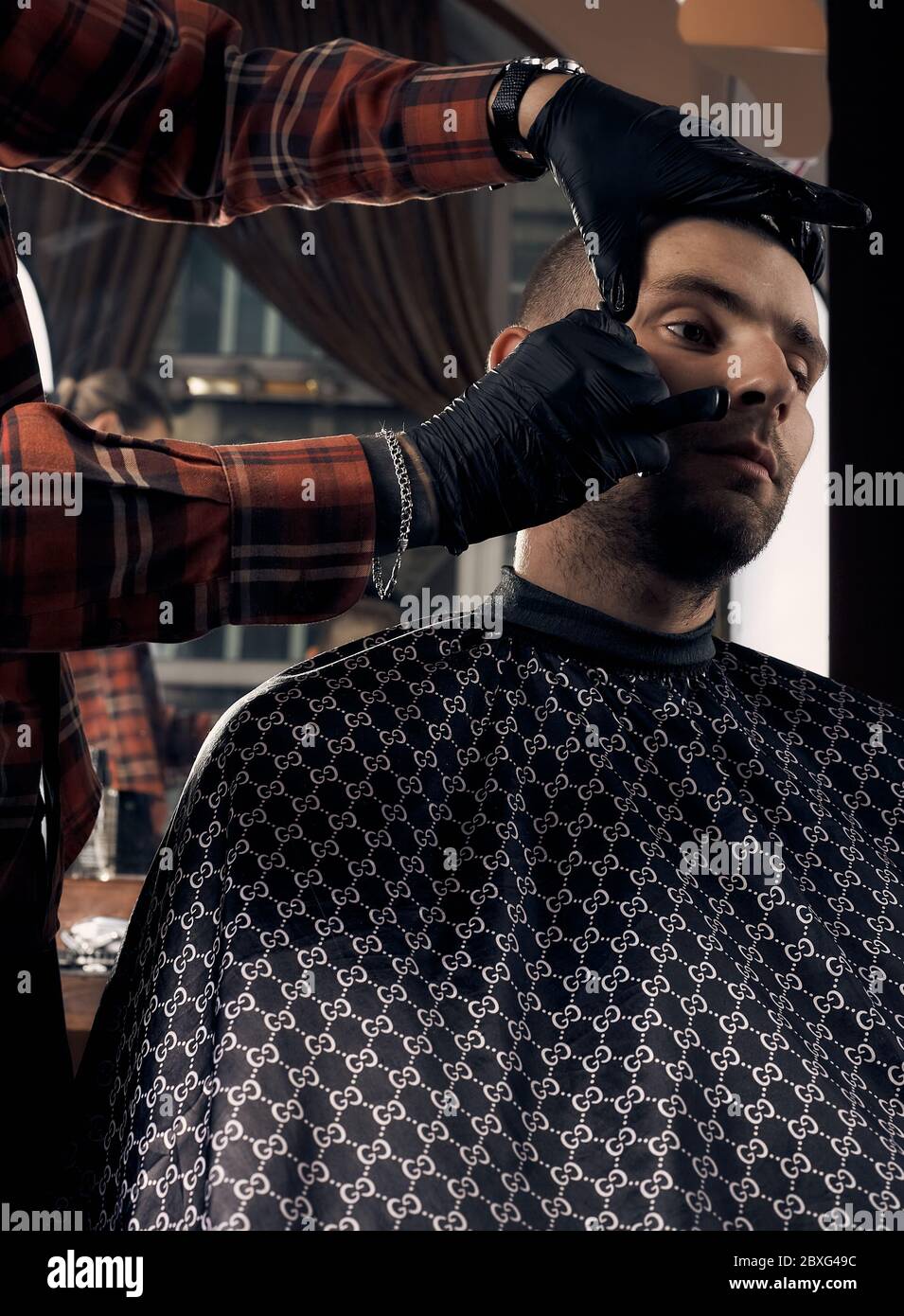 Barber cuts a guy at the hairdresser. Short haircut and alignment of ...