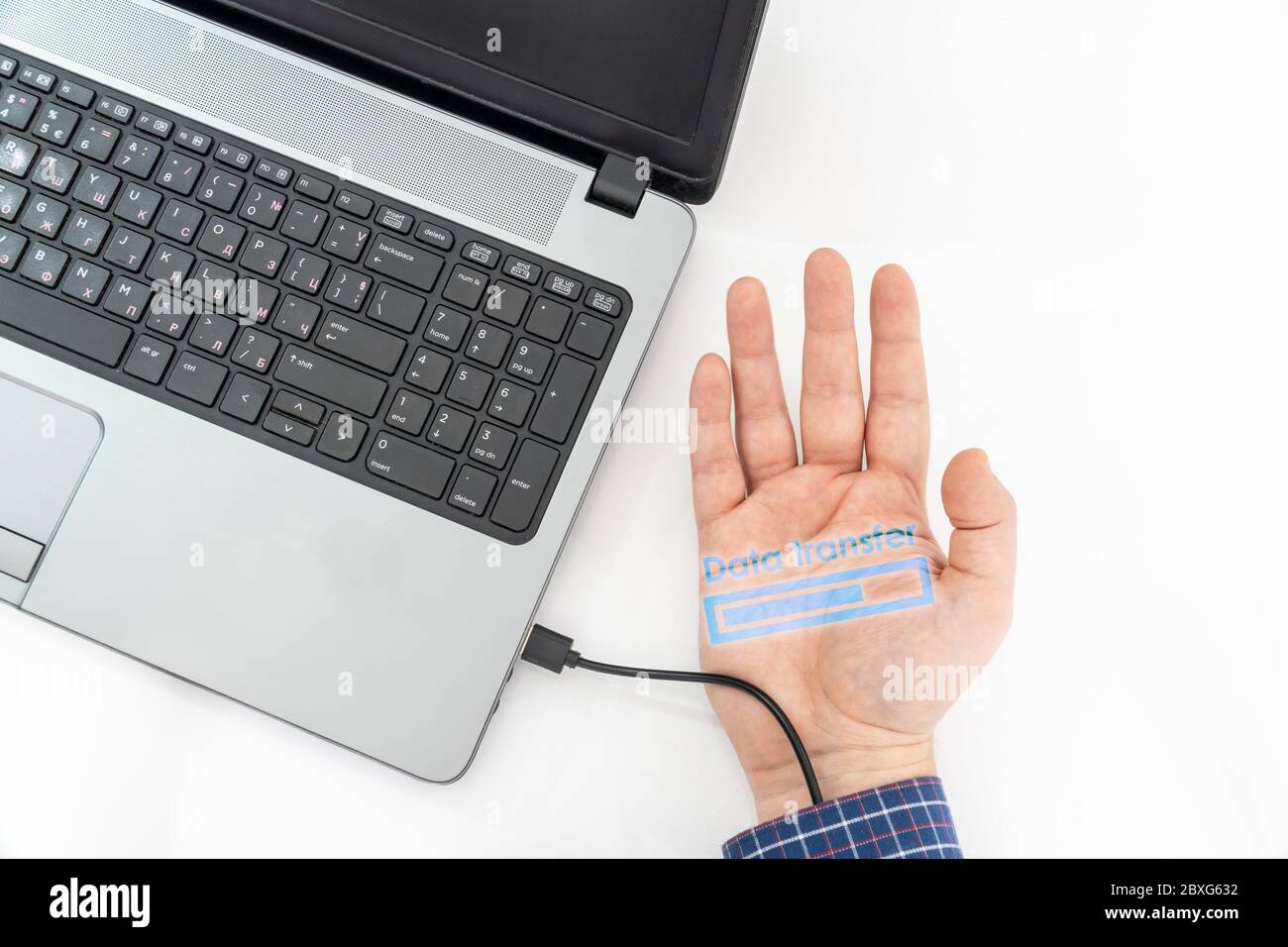 Augmented human hand connected to a laptop via usb cable and ...