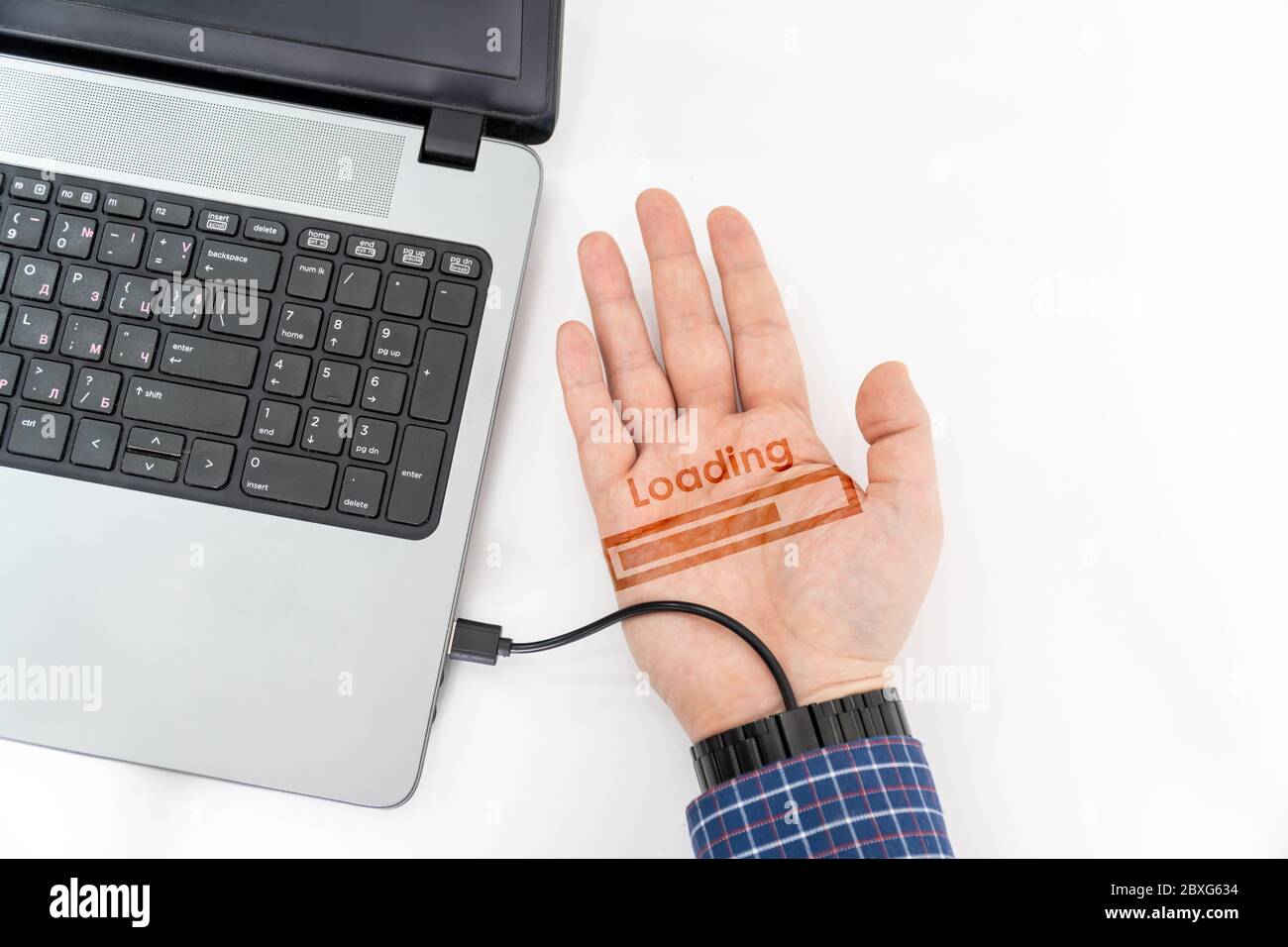 Augmented human hand connected to a laptop via usb cable and ...