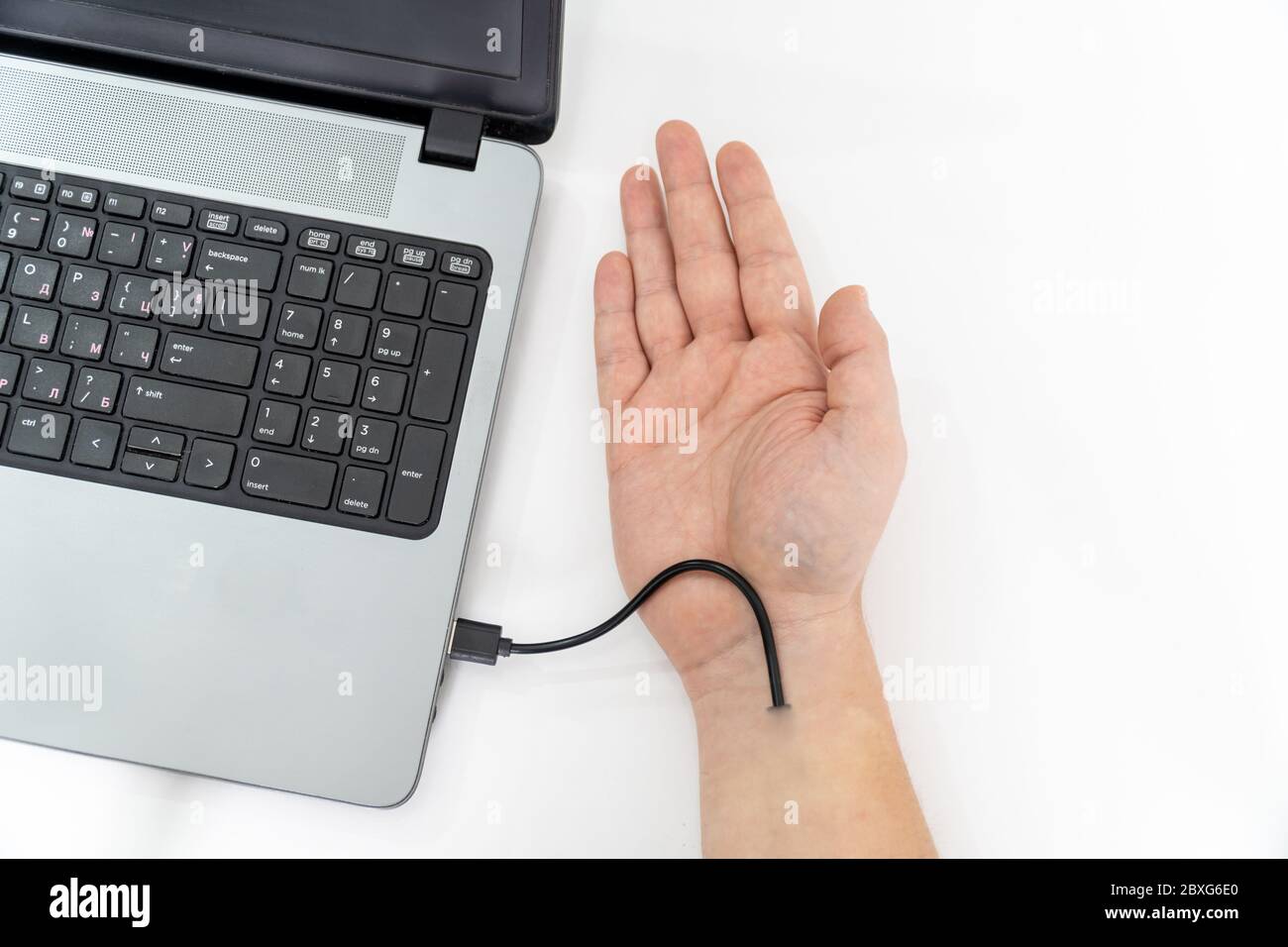 Augmented human hand connected to a laptop via usb cable and ...
