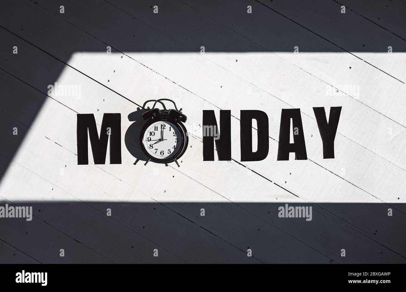 Word Monday in sunlight with an alarm clock Stock Photo - Alamy