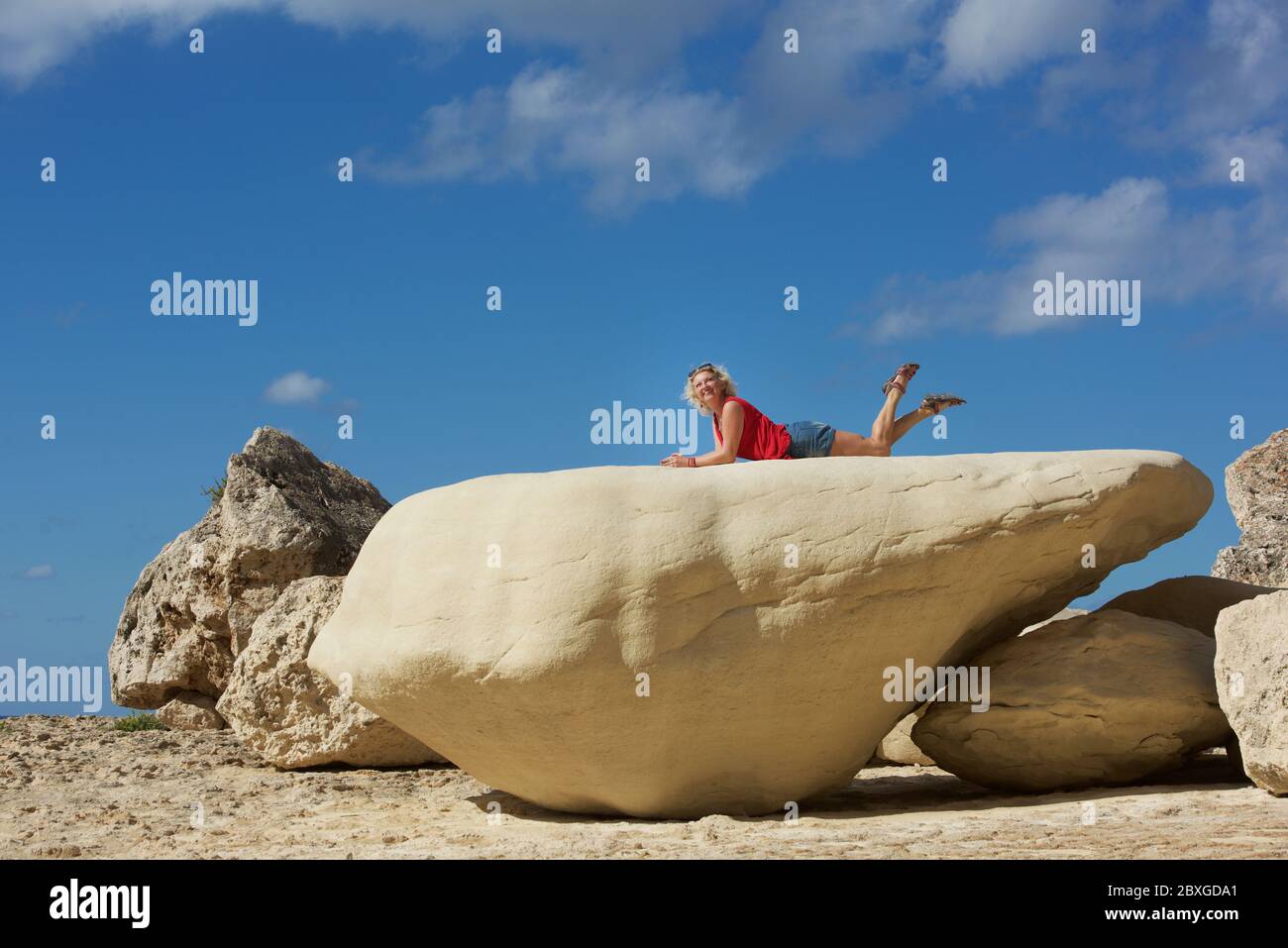 Woman lying on a giant rock, Bahrija, Malta Stock Photo - Alamy
