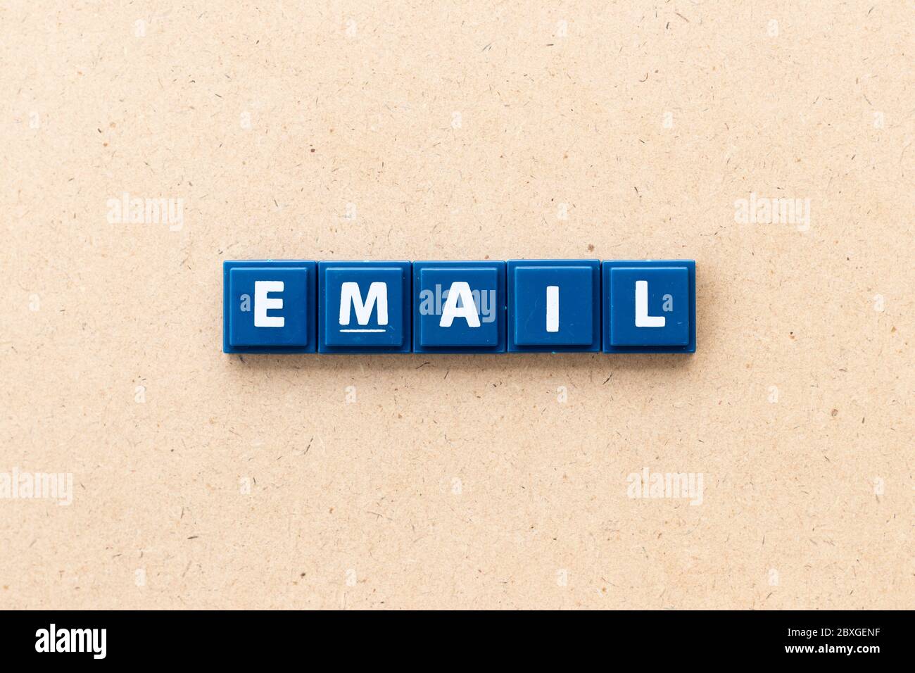 Tile letter in word email on wood background Stock Photo - Alamy