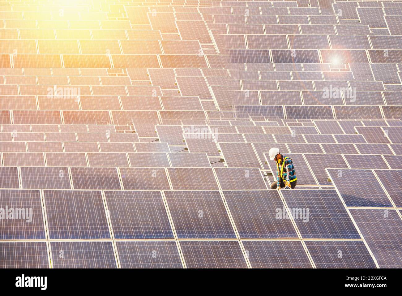 Portrait of an engineer working on solar panels at a solar powered ...