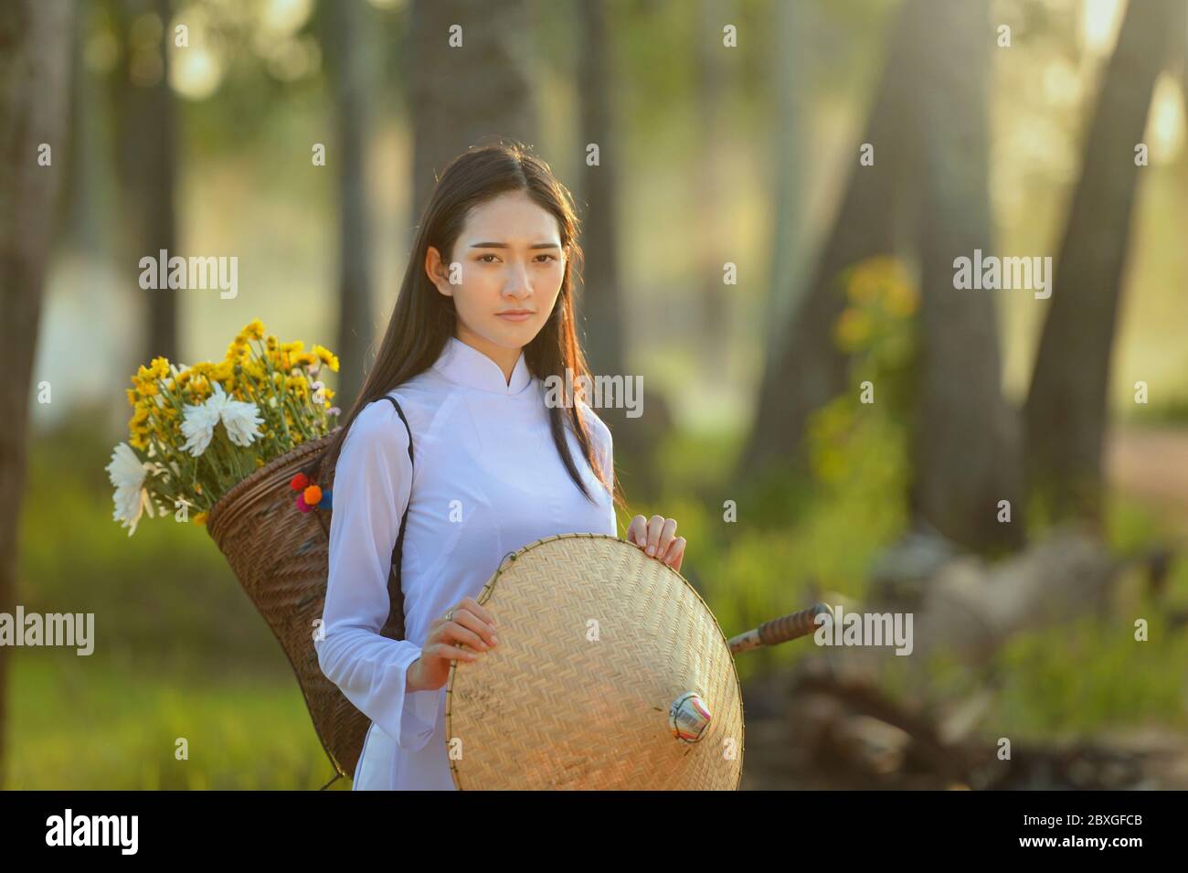 Beautiful woman wearing traditional clothing holding a non la hat ...