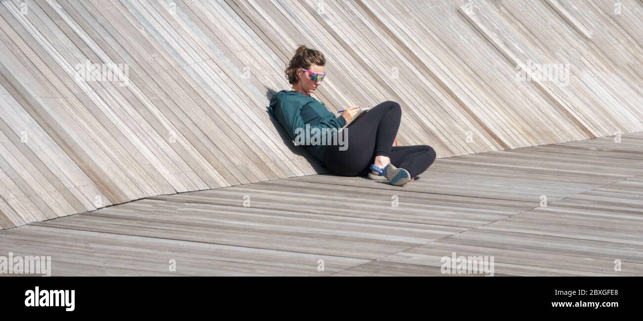 Girl reading C-Square Plaza East Villige Calgary Alberta Stock Photo ...