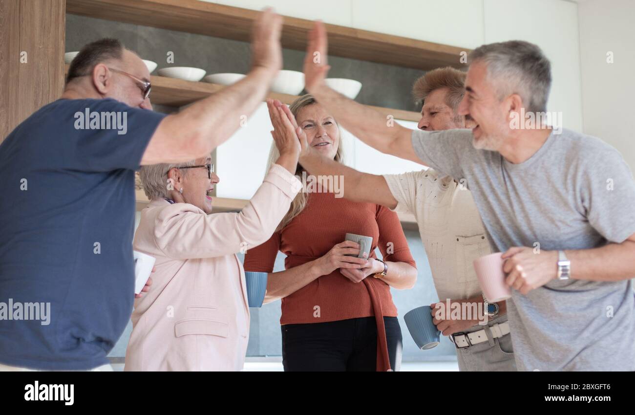 happy friends giving each other a high five Stock Photo - Alamy