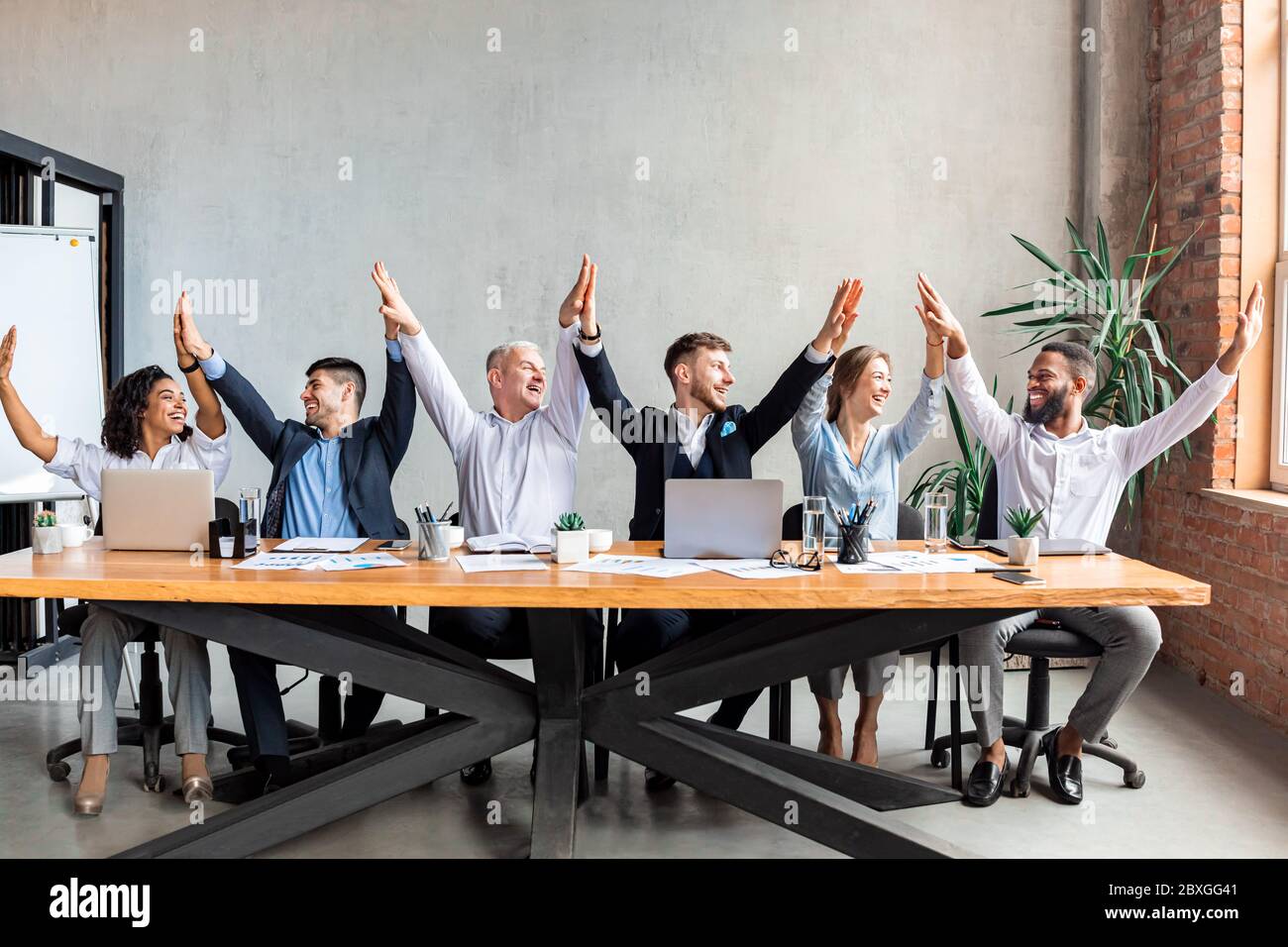 Happy Coworkers Giving High-Five Rejoicing Success At Work In Office ...