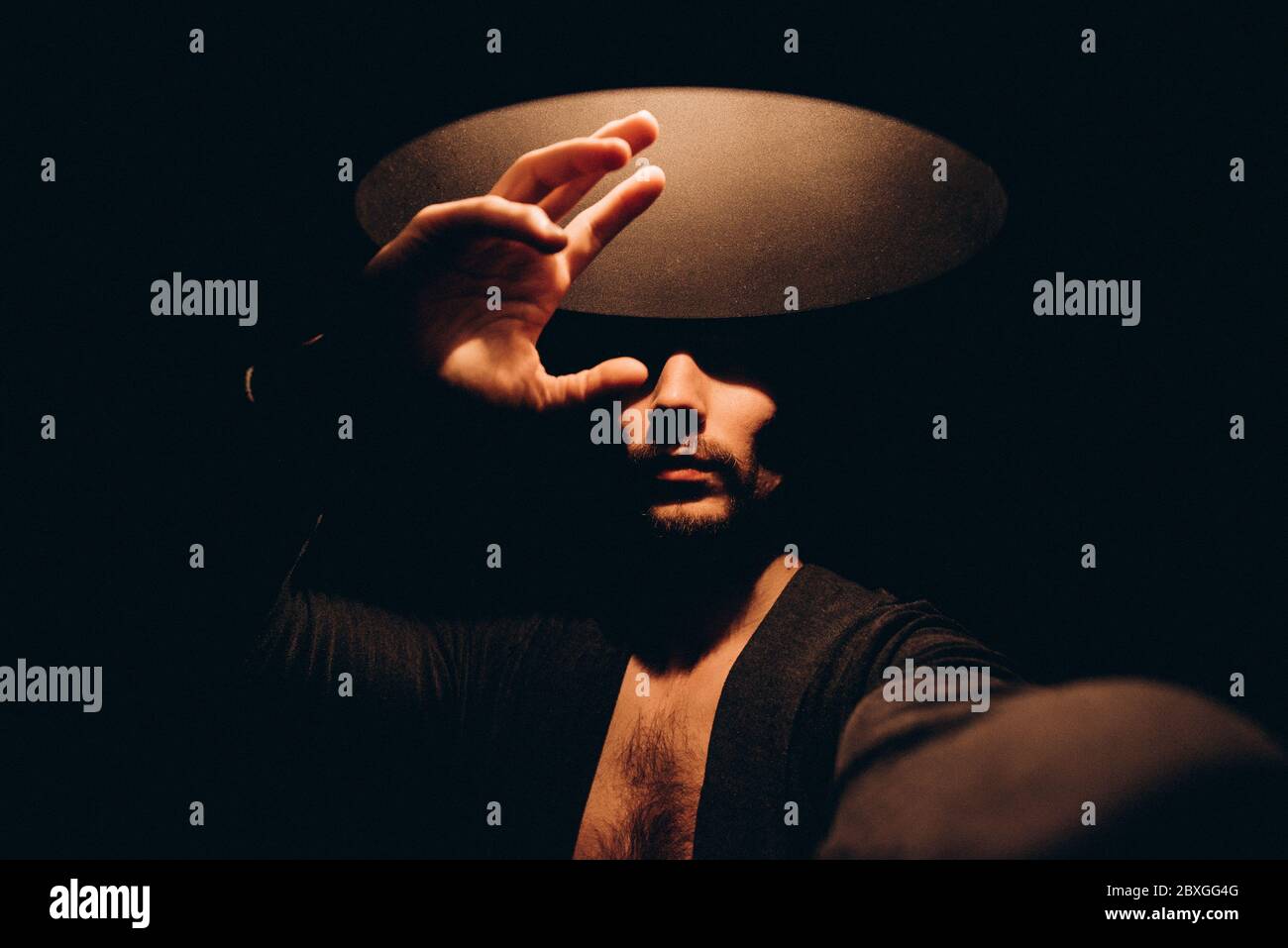 Portrait of a man standing under a lamp Stock Photo - Alamy