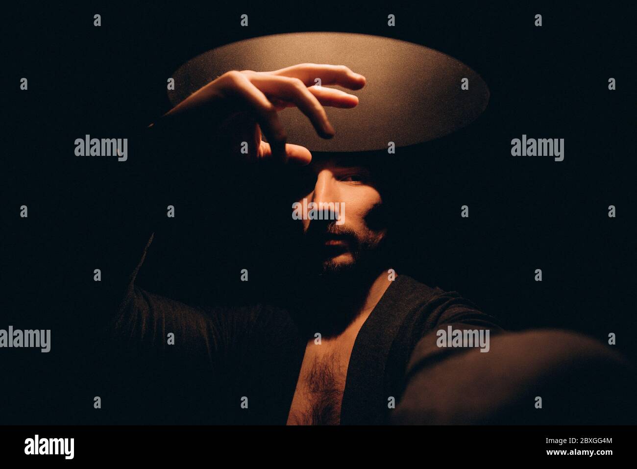 Portrait of a man standing under a lamp Stock Photo - Alamy