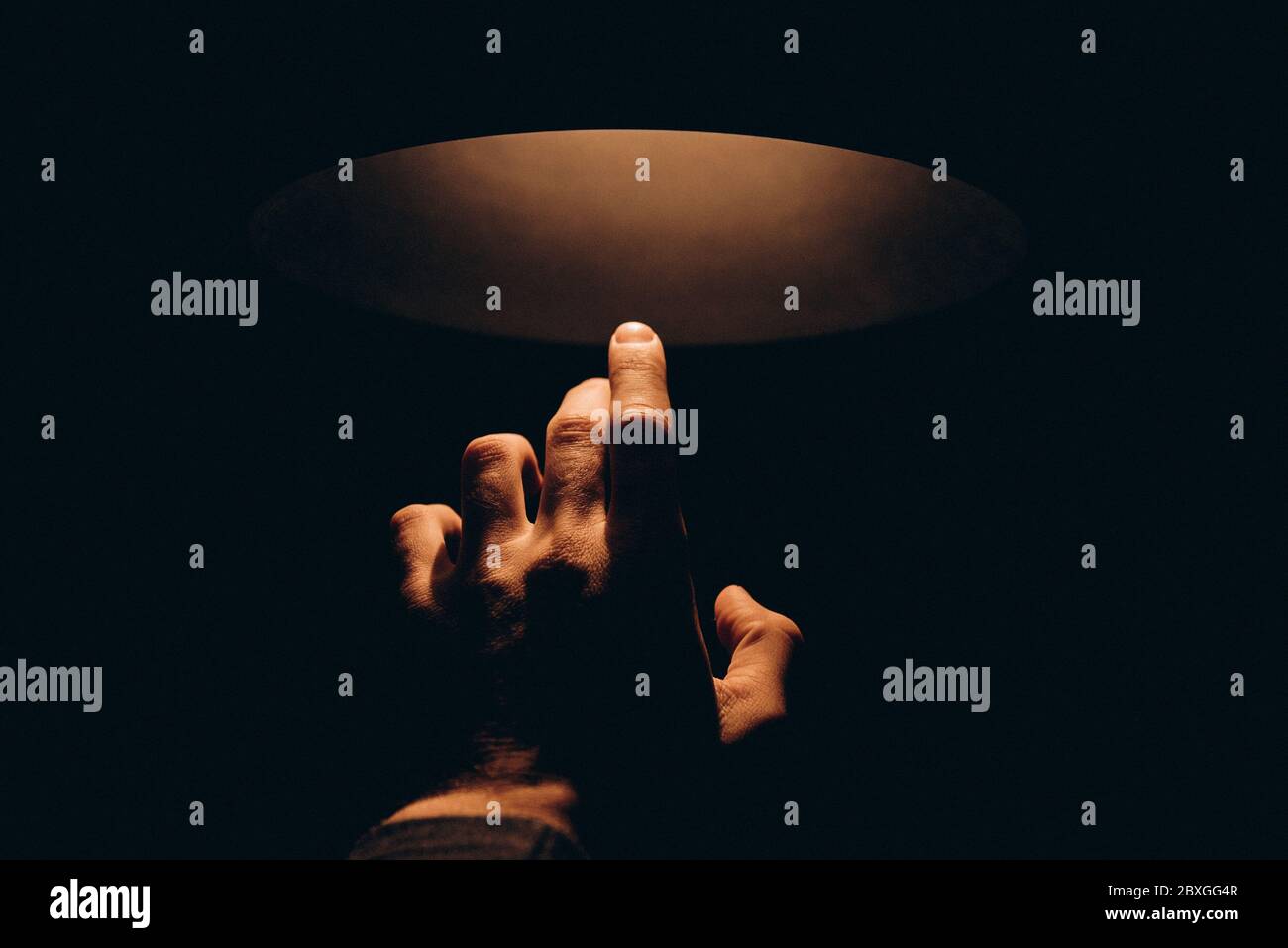Man's hand reaching for the light Stock Photo - Alamy