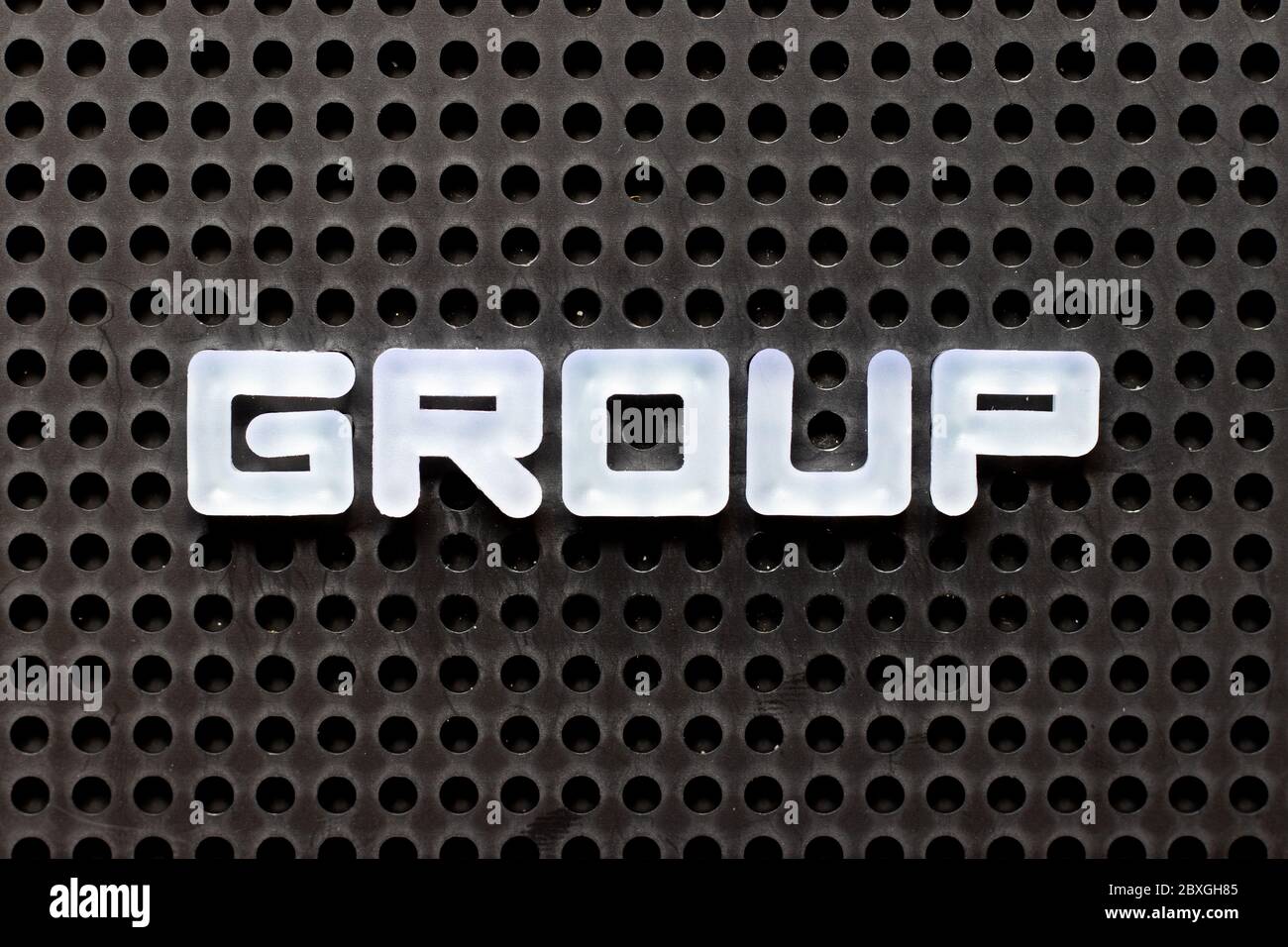 White color alphabet with word group on black pegboard background Stock ...