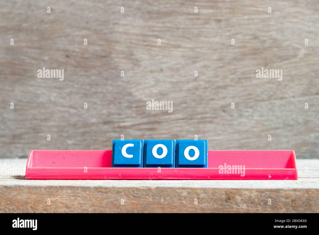 Tile letter on red rack in word COO (abbreviation Chief operating ...