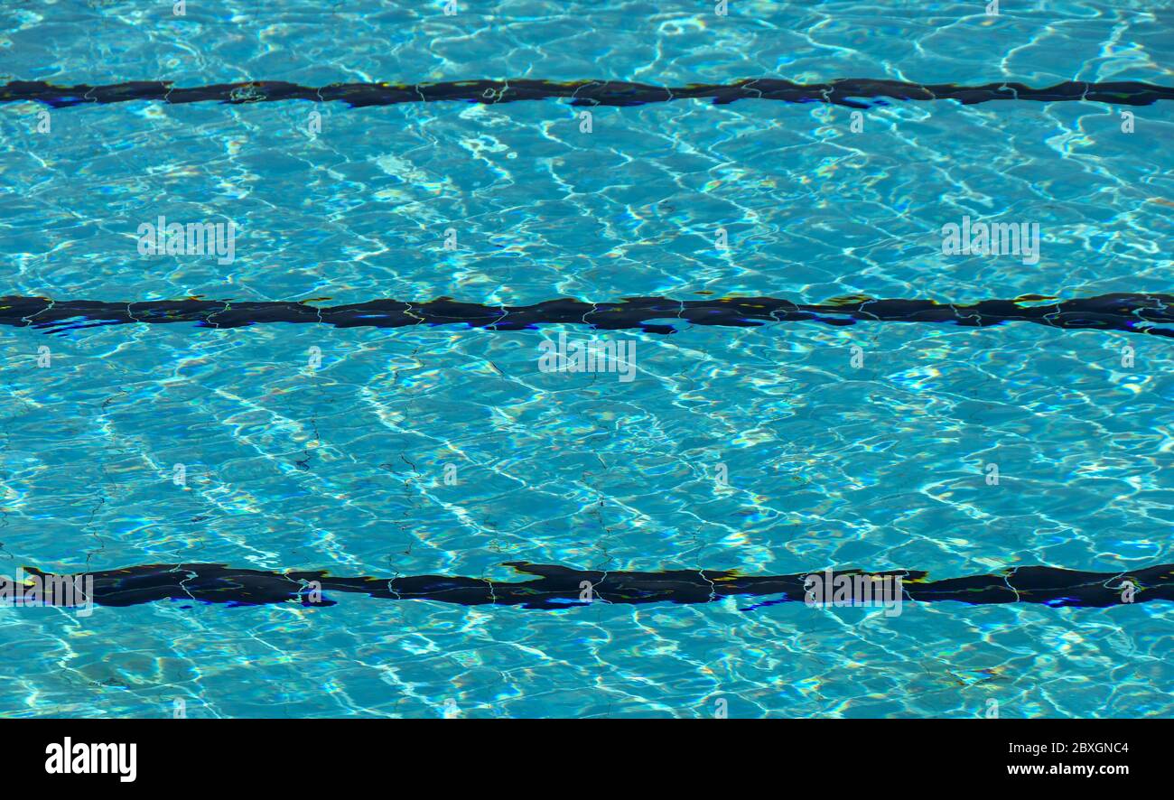 Patterns formed by morning sunlight on the water in an outdoor swimming ...