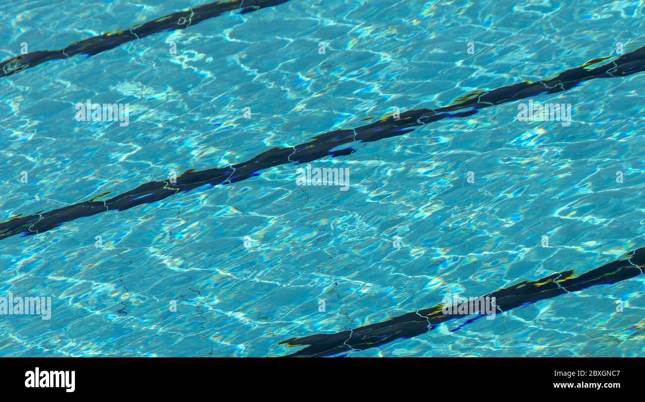 Patterns formed by morning sunlight on the water in an outdoor swimming ...