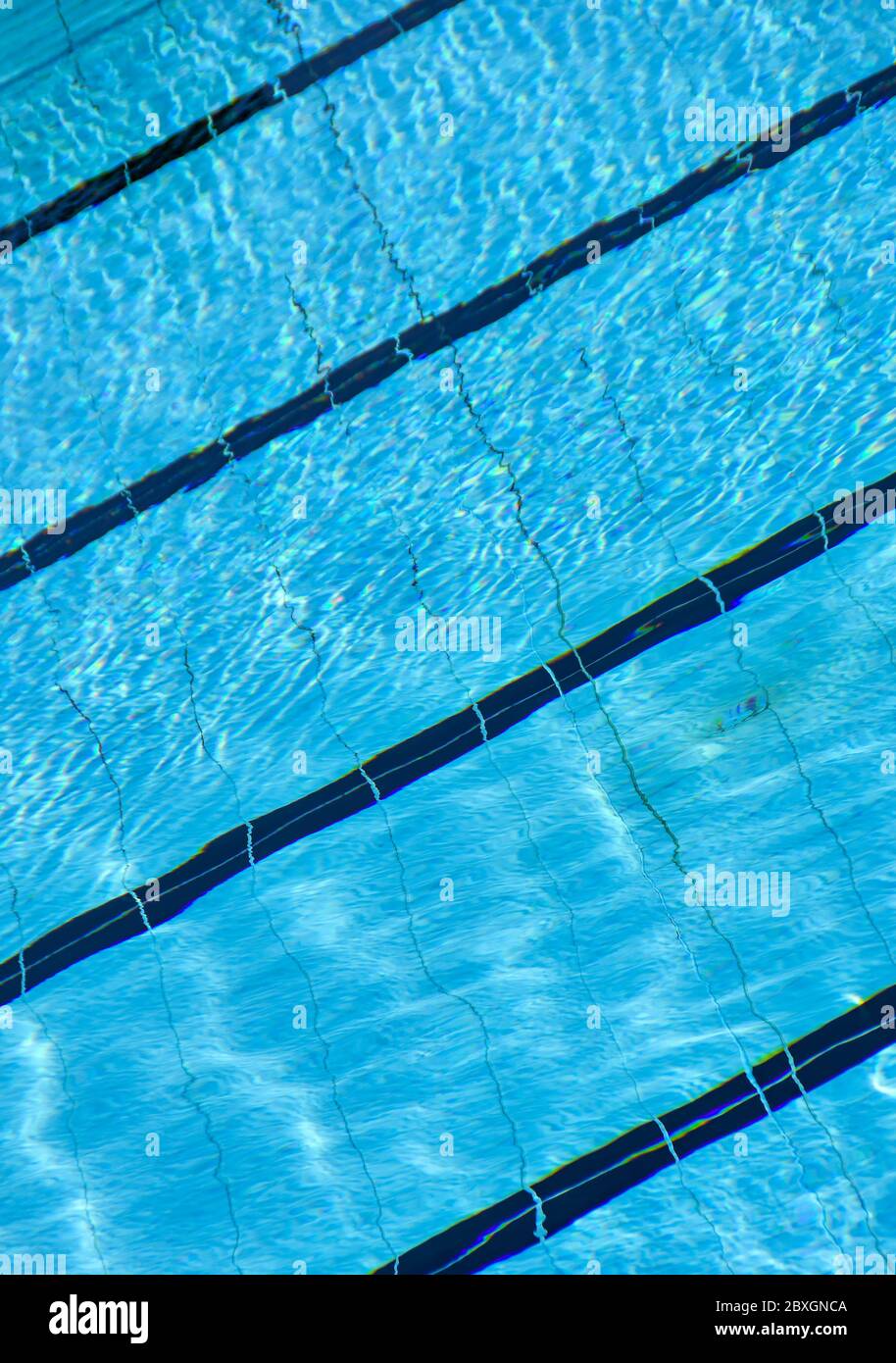Patterns formed by sunlight on the water in an outdoor swimming pool ...