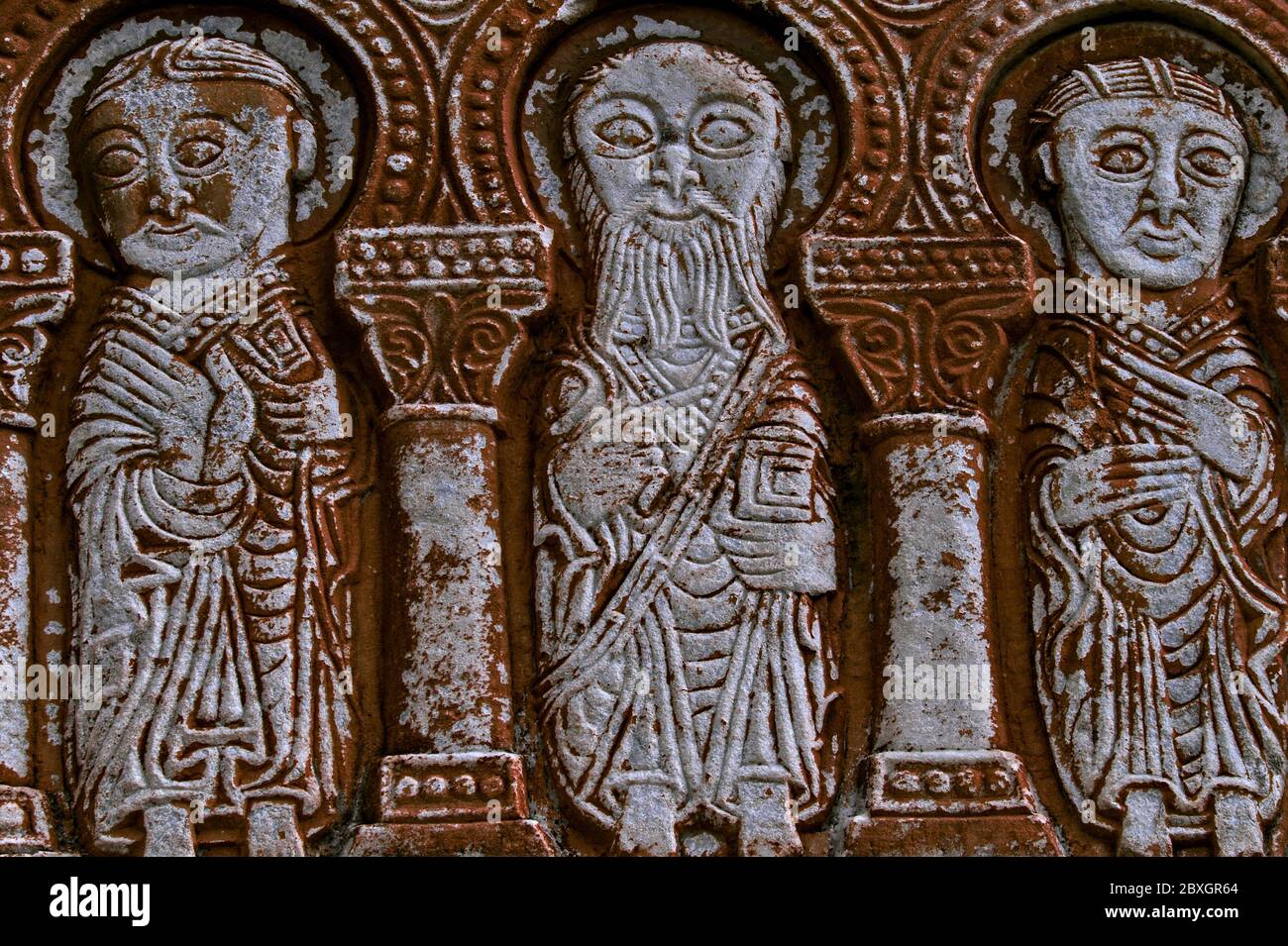 Three standing male figures in an arcade. Sculpted in the early 1000s ...