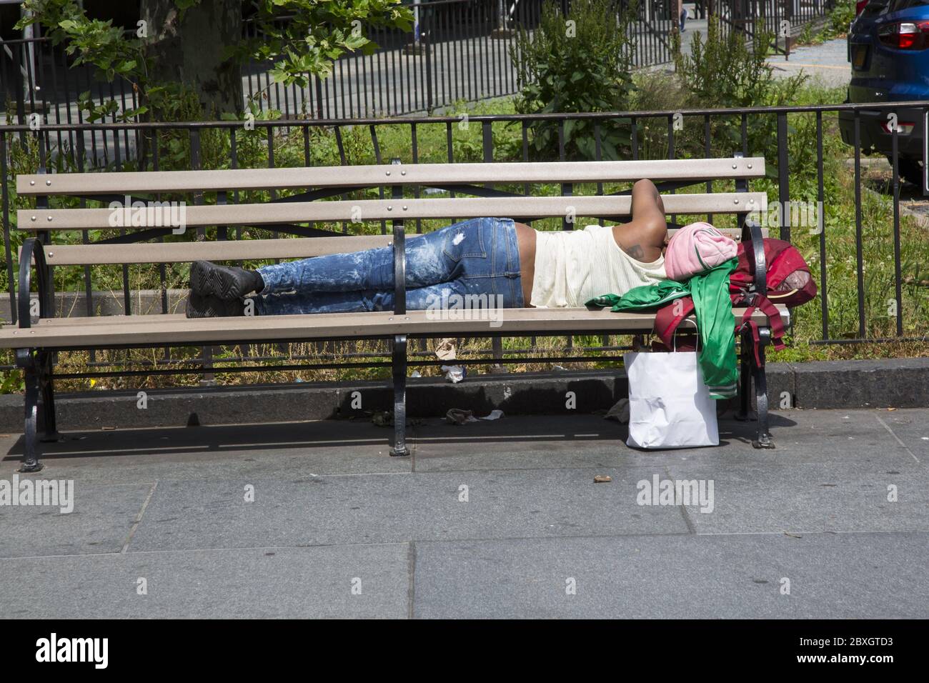 Man takes a nap on a bench at Cadman Plaza in Brooklyn, New York Stock ...