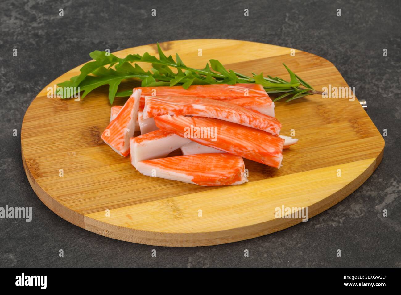 Crab stick surimi over wooden board Stock Photo - Alamy