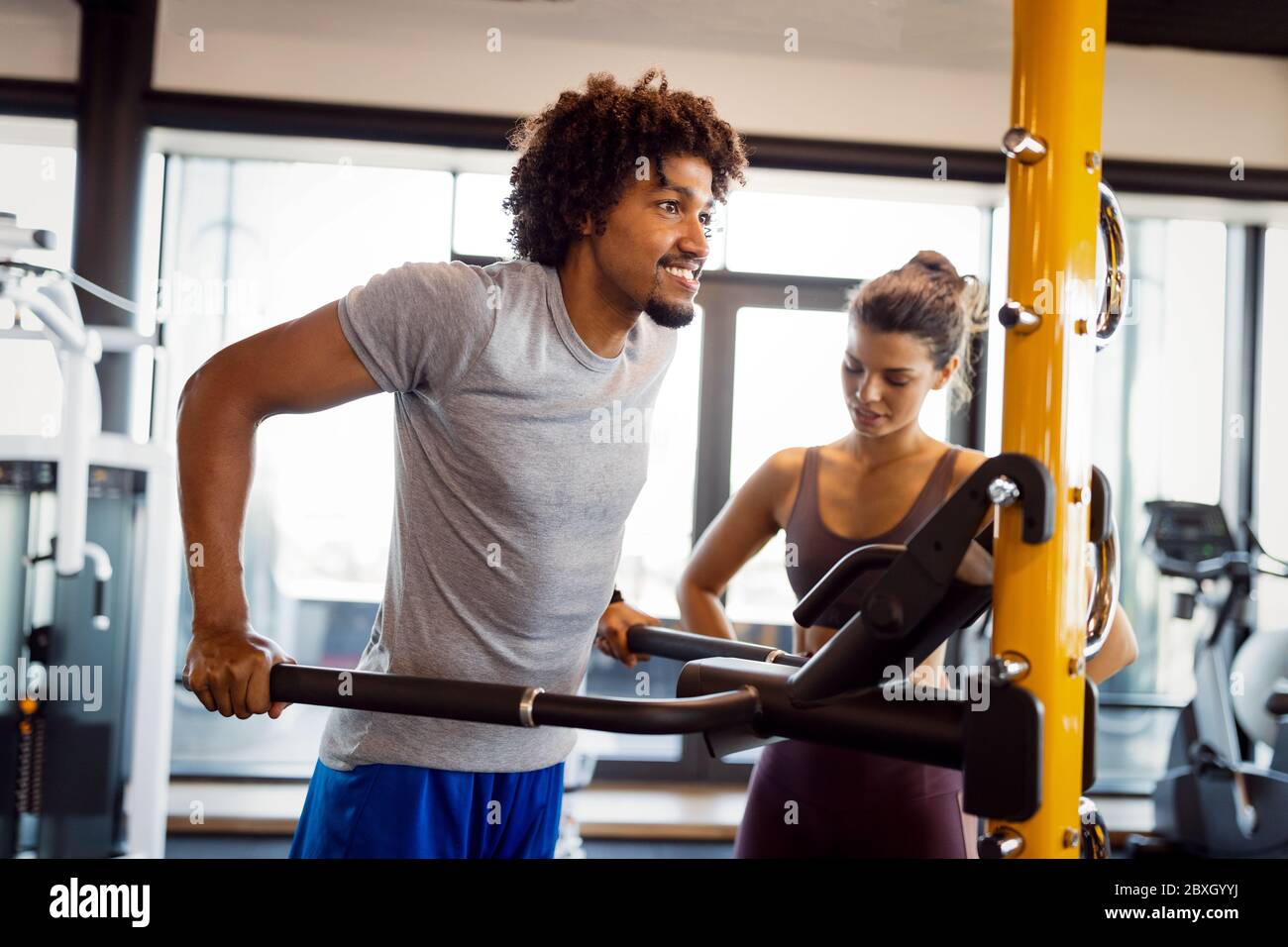 Teamwork in gym. Couple working exercise together Stock Photo - Alamy
