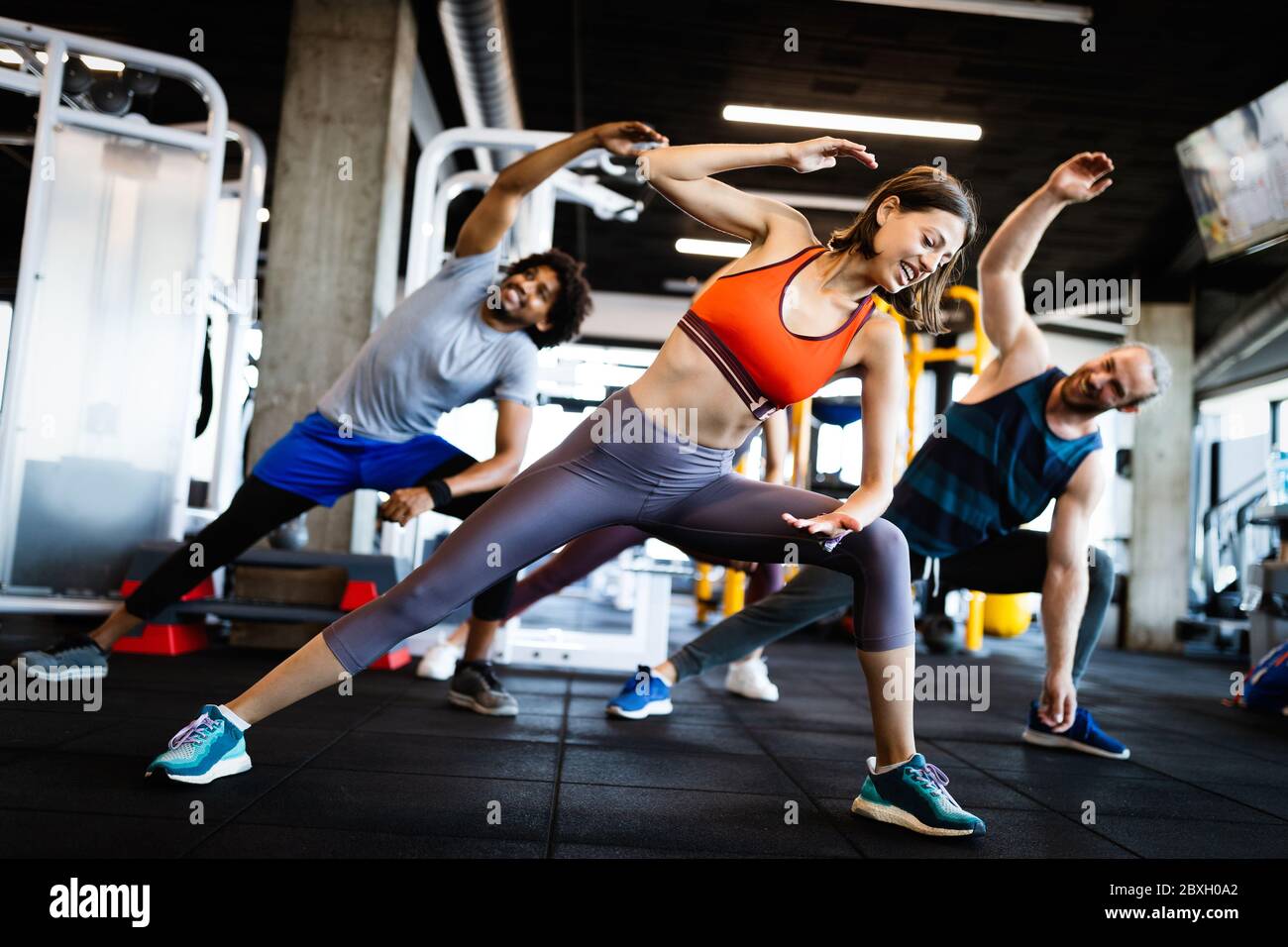 Beautiful fit people working out in gym together Stock Photo - Alamy