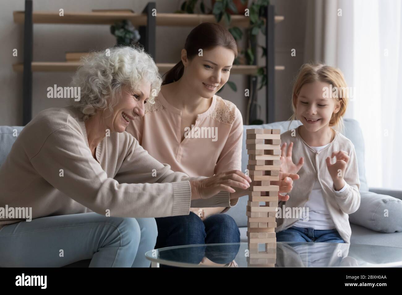 Happy three generations of women play at home together Stock Photo - Alamy